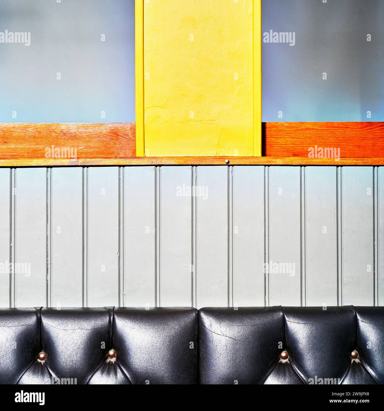 Seating area with yellow pillar Stock Photo - Alamy