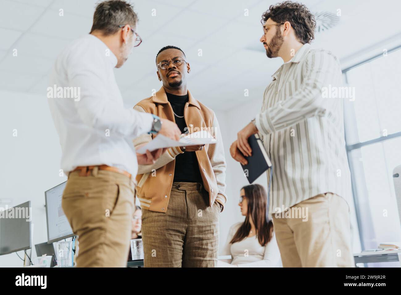 Multi-generational team working together on project tasks and revenue ...