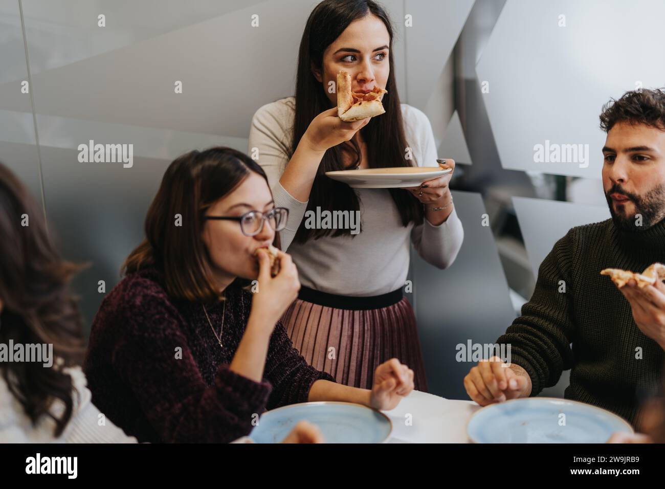 Successful business people enjoying a pizza lunch break together Stock ...