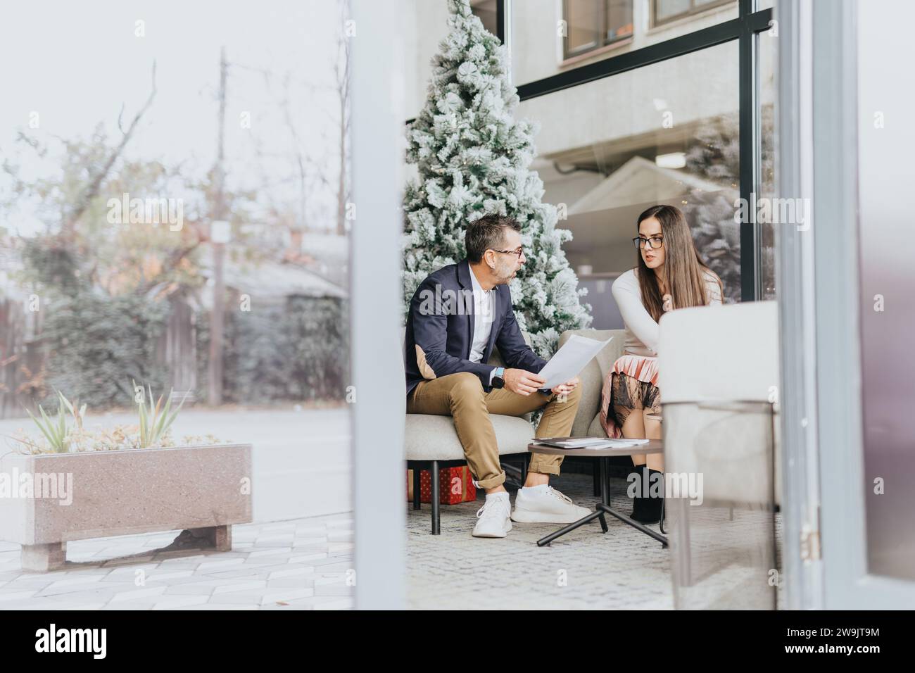 Small Team Of Business Professionals Collaborating In An Office Analyzing Statistics And