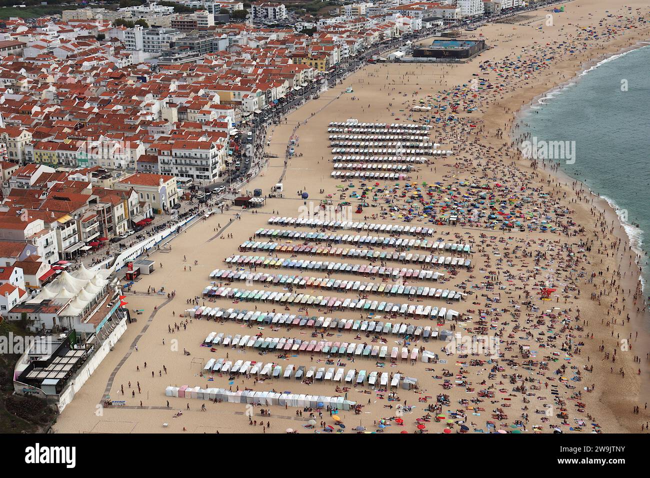 Aerial view of people at Nazaré Beach, Portugal, including a partial ...