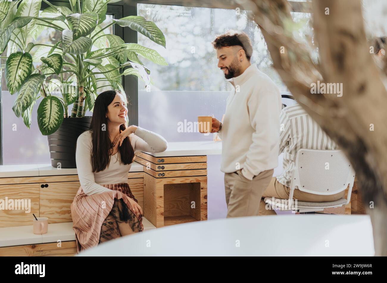 Young professionals collaborate in a modern office, planning strategies for business growth and ...