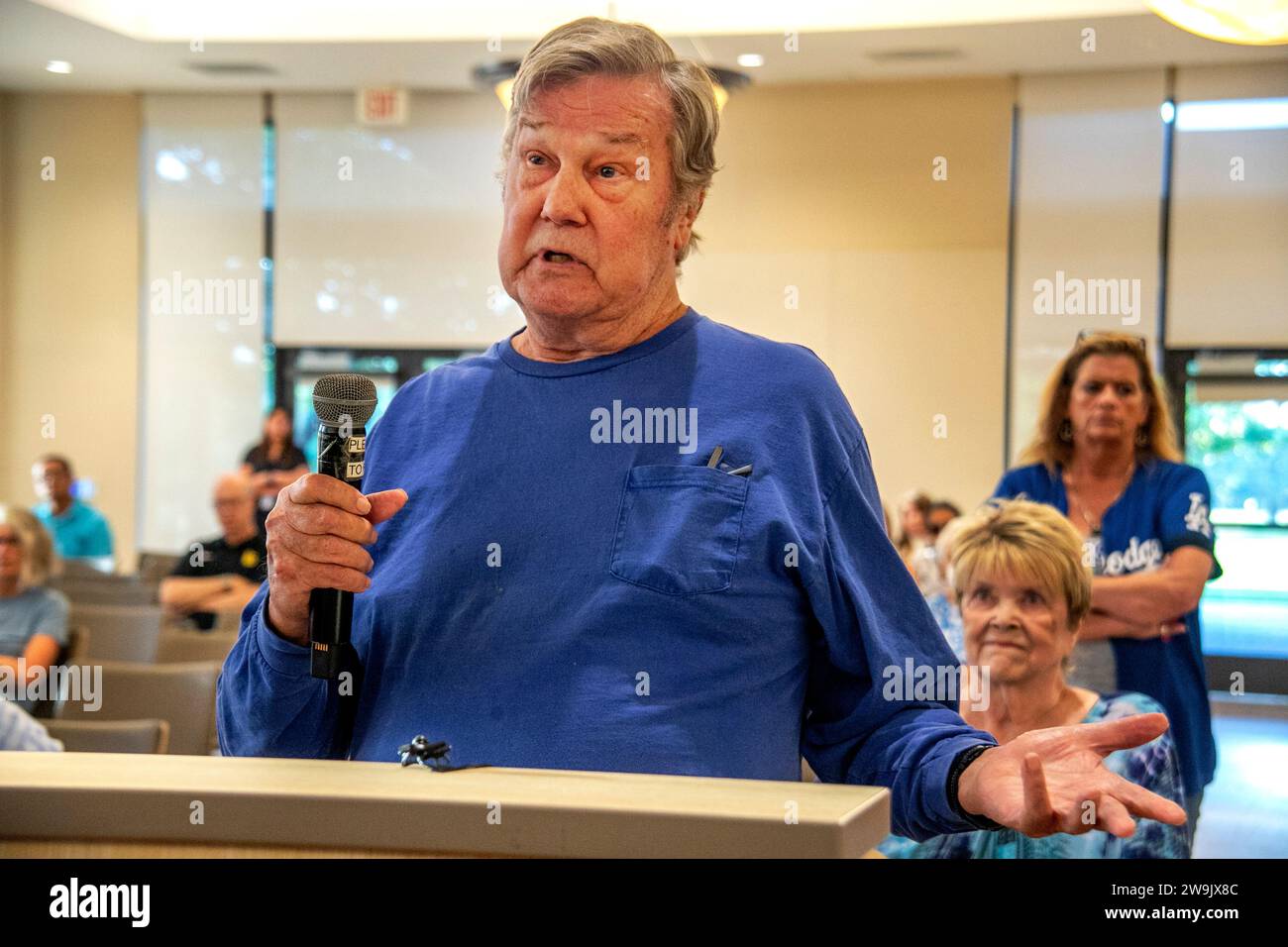 A local citizen gives his opinion on city government issues at a town ...