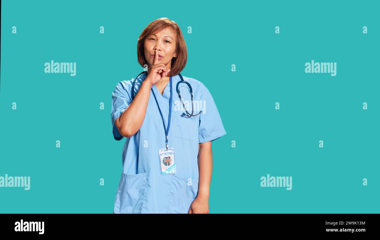 Asian woman shushing hi-res stock photography and images - Alamy