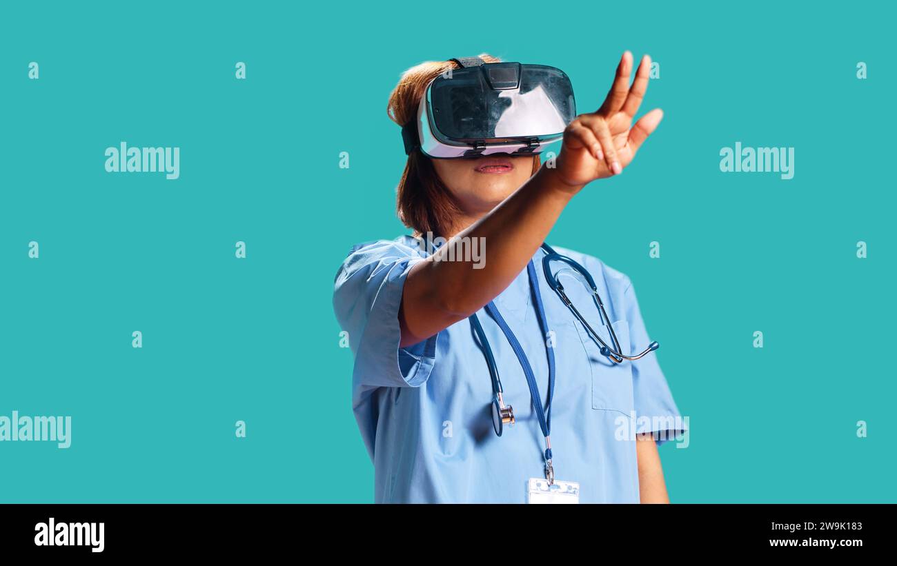 Healthcare professional wearing virtual reality headset remotely ...