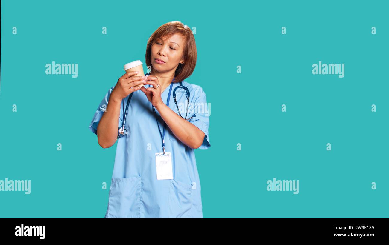 Healthcare Specialist Tasting Fresh Cup Of Coffee While At Work