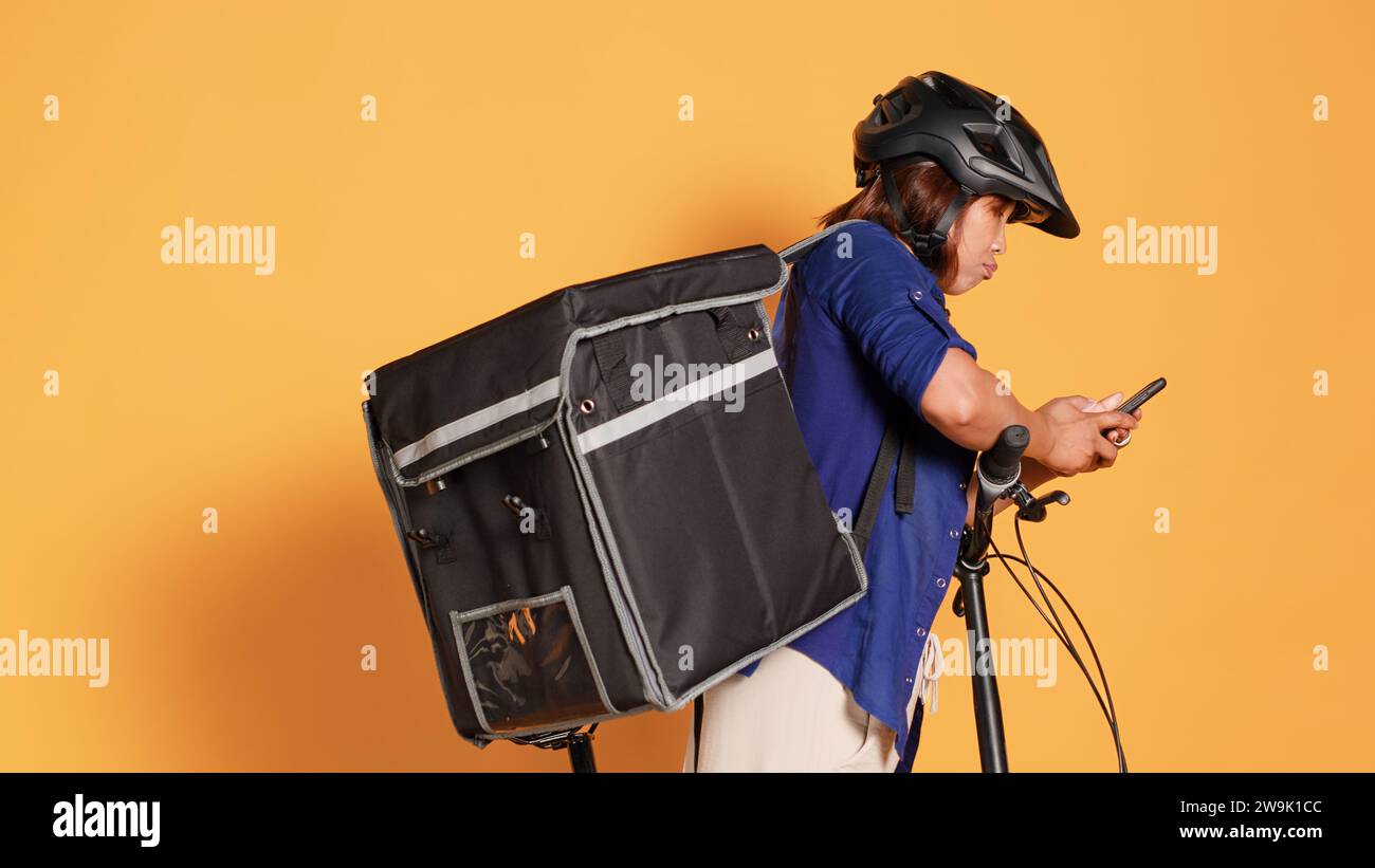 Handheld camera shot of courier texting client after delivering wrong ...