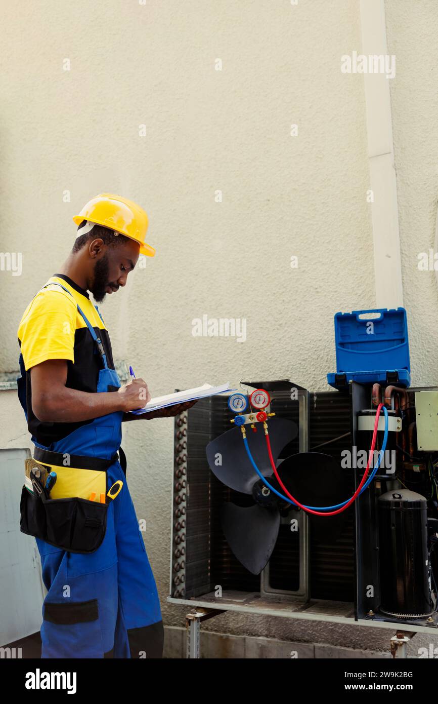 Certified technician doing inspection of freon levels and necessary ...