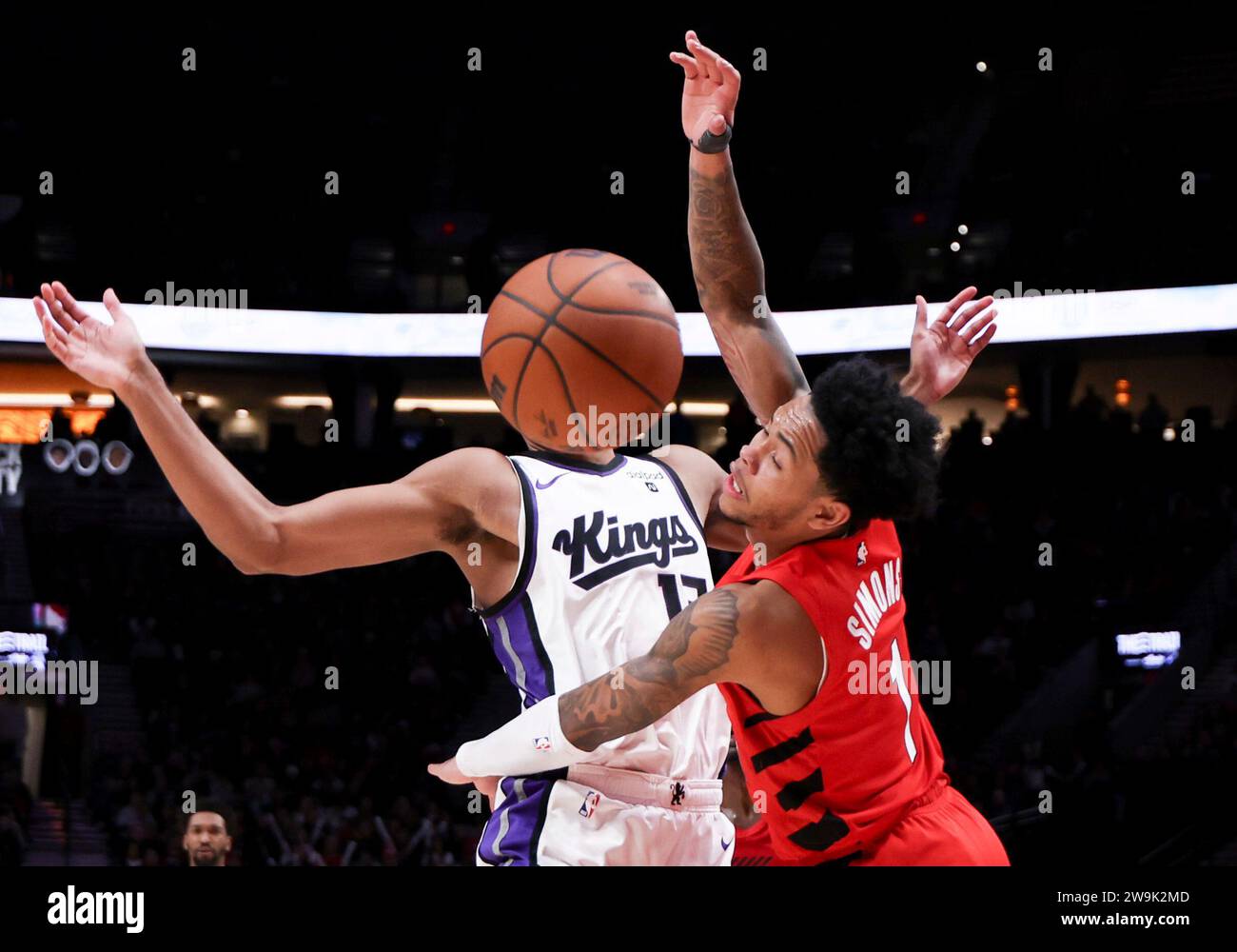 Portland Trail Blazers guard Anfernee Simons, right, knocks the ball loose from Sacramento Kings ...