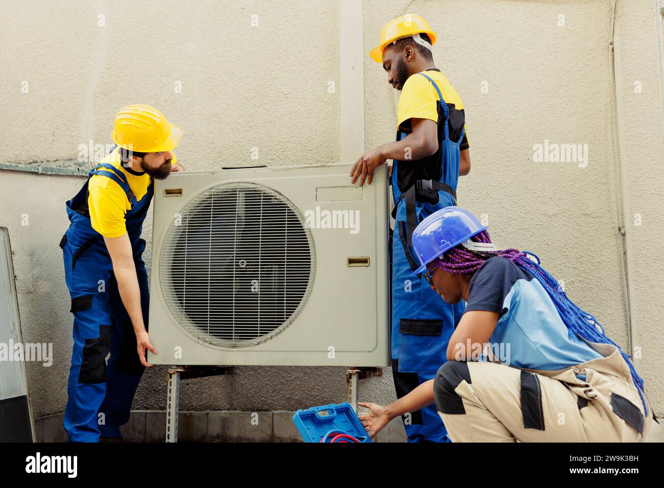 Knowleadgeable engineering team installing new outdoor air conditioner ... Knowleadgeable engineering team installing new outdoor air conditioner ...