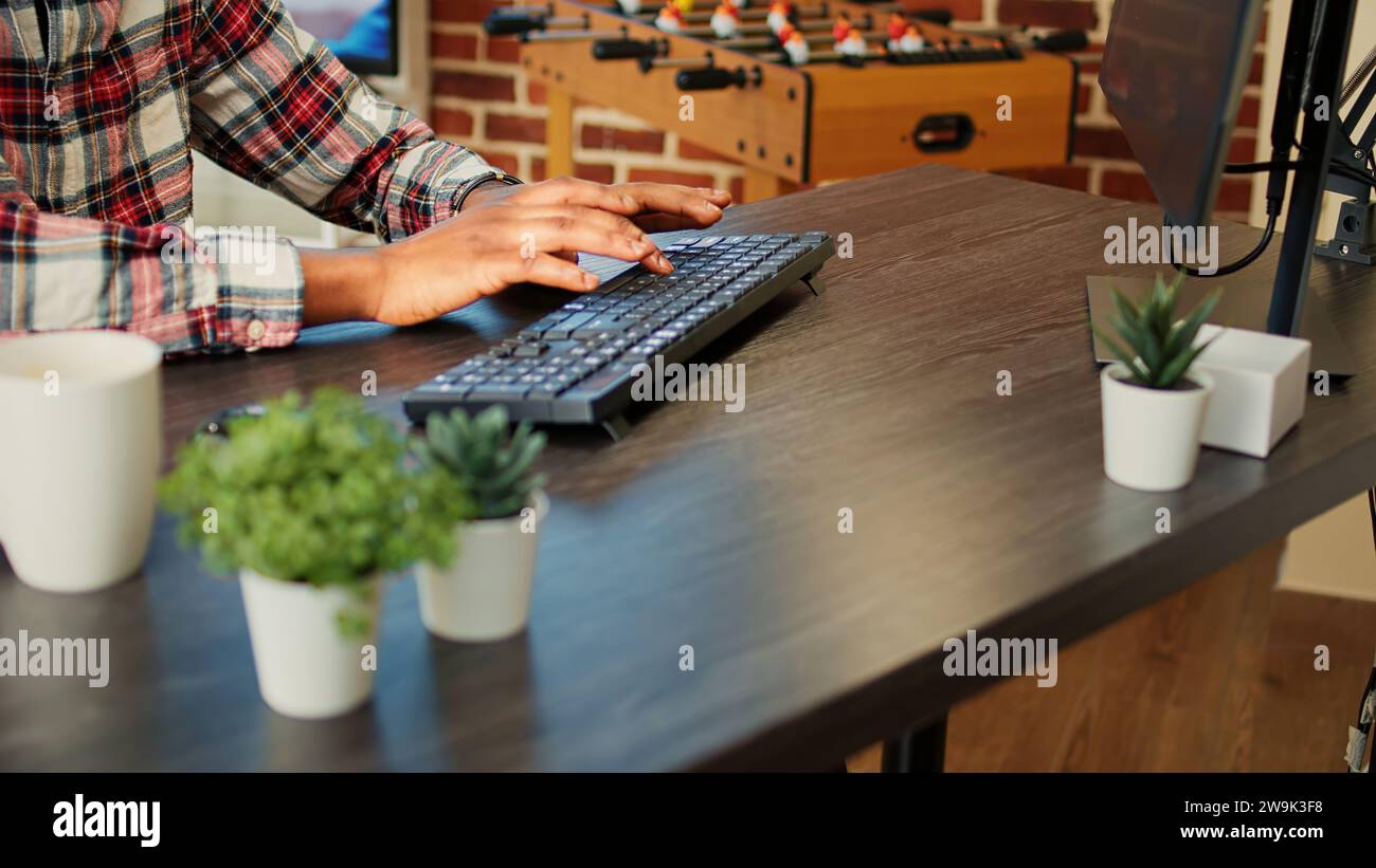 Employee remotely working from home on computer, inputing data in his ...