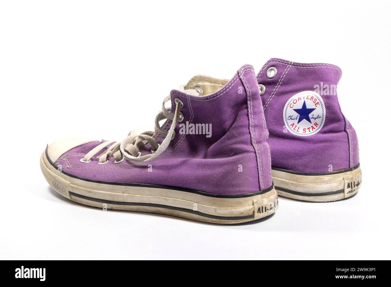 Pair of worn purple Converse All Star sneakers with white laces and a ...