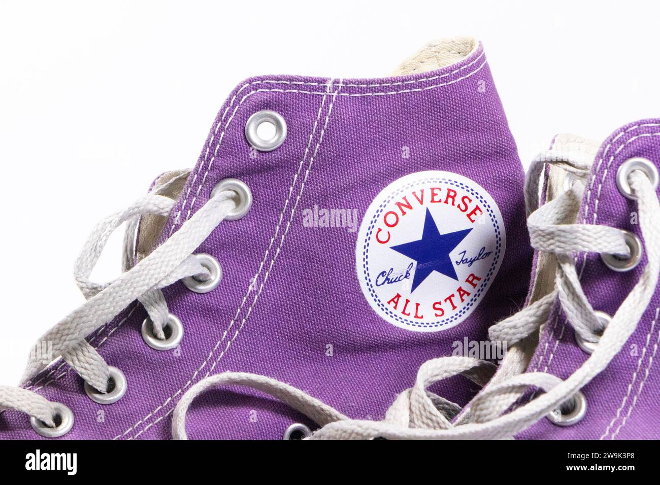 Close-up of purple Converse All Star sneakers with white laces against ...