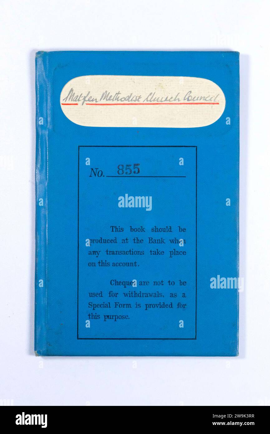 A vintage blue bank account book with handwritten text on a label ...