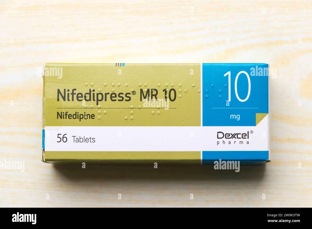10mg Dexcel Nifedipress MR 10 tablets used to treat high blood pressure in box isolated on wood ...