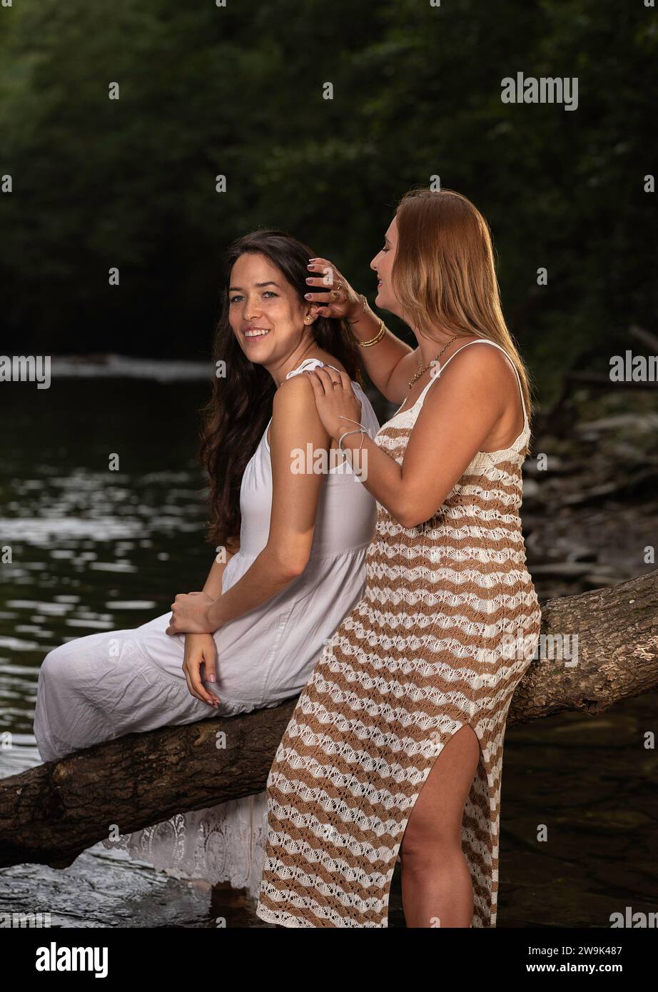 two girls enjoying nature by the river Stock Photo - Alamy