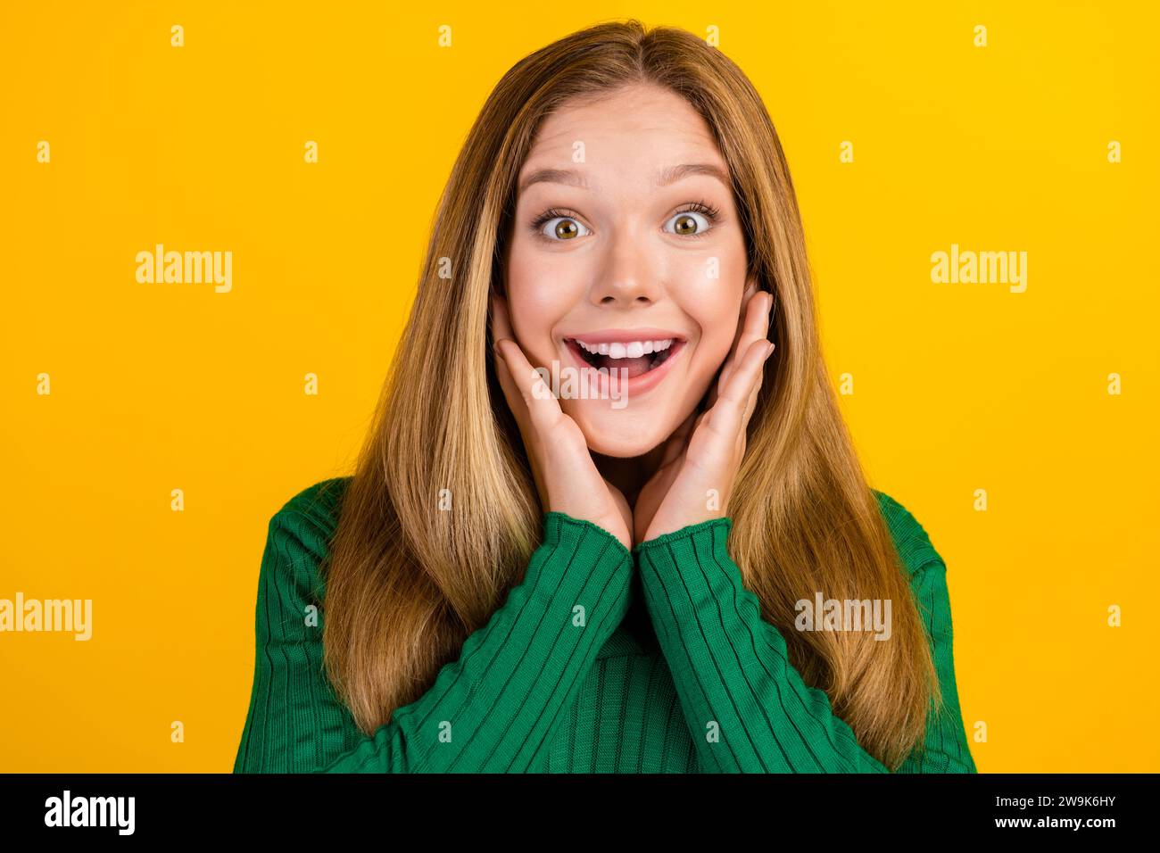 Photo of funky astonished person beaming smile arms touch cheekbones ...