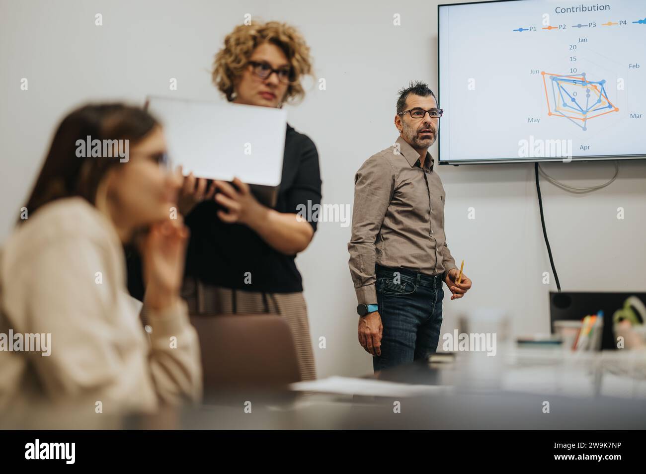 Successful brainstorming session with confident, multi generational ...