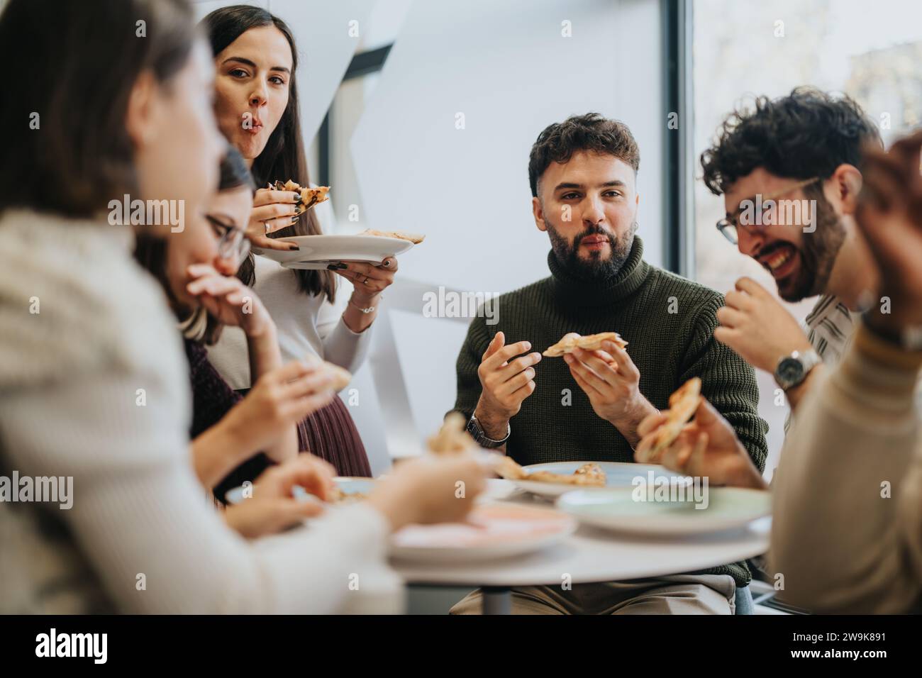 Successful business people taking a refreshing break and enjoying pizza ...