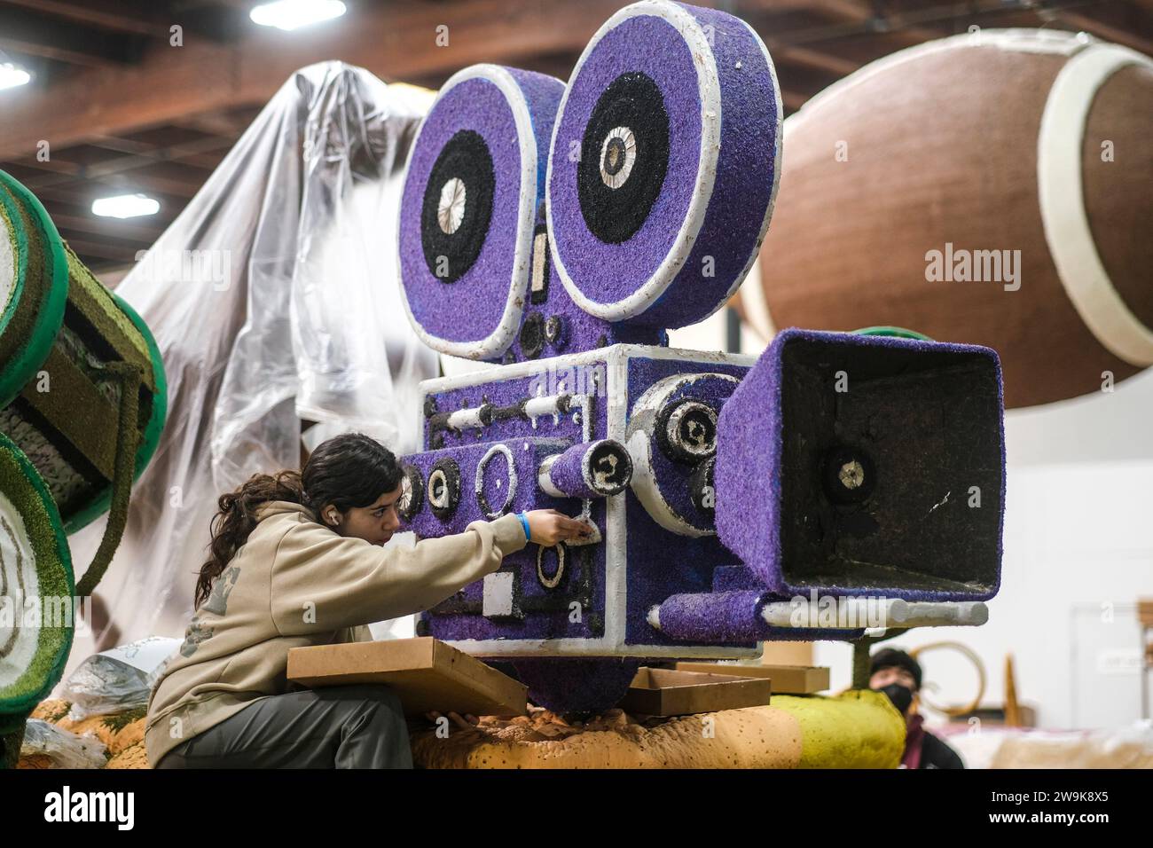 A volunteer works on a float for the 135th Rose Parade in Pasadena ...