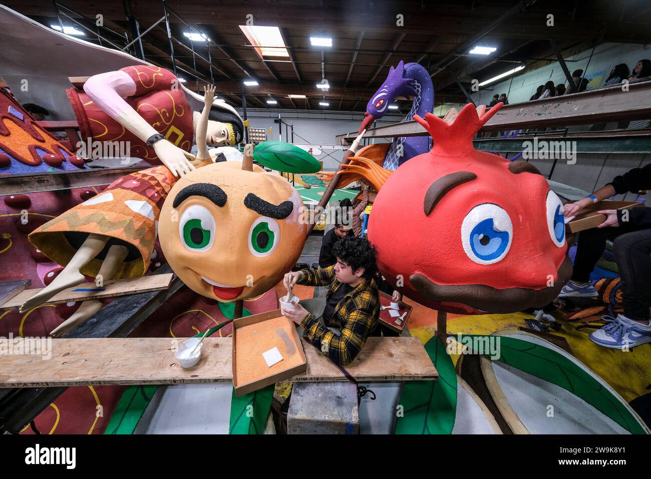 A volunteer works on a float for the 135th Rose Parade in Pasadena ...