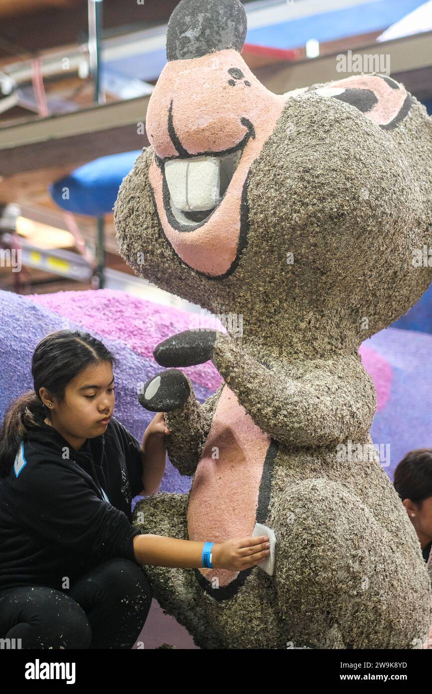 A volunteer works on a float for the 135th Rose Parade in Pasadena ...