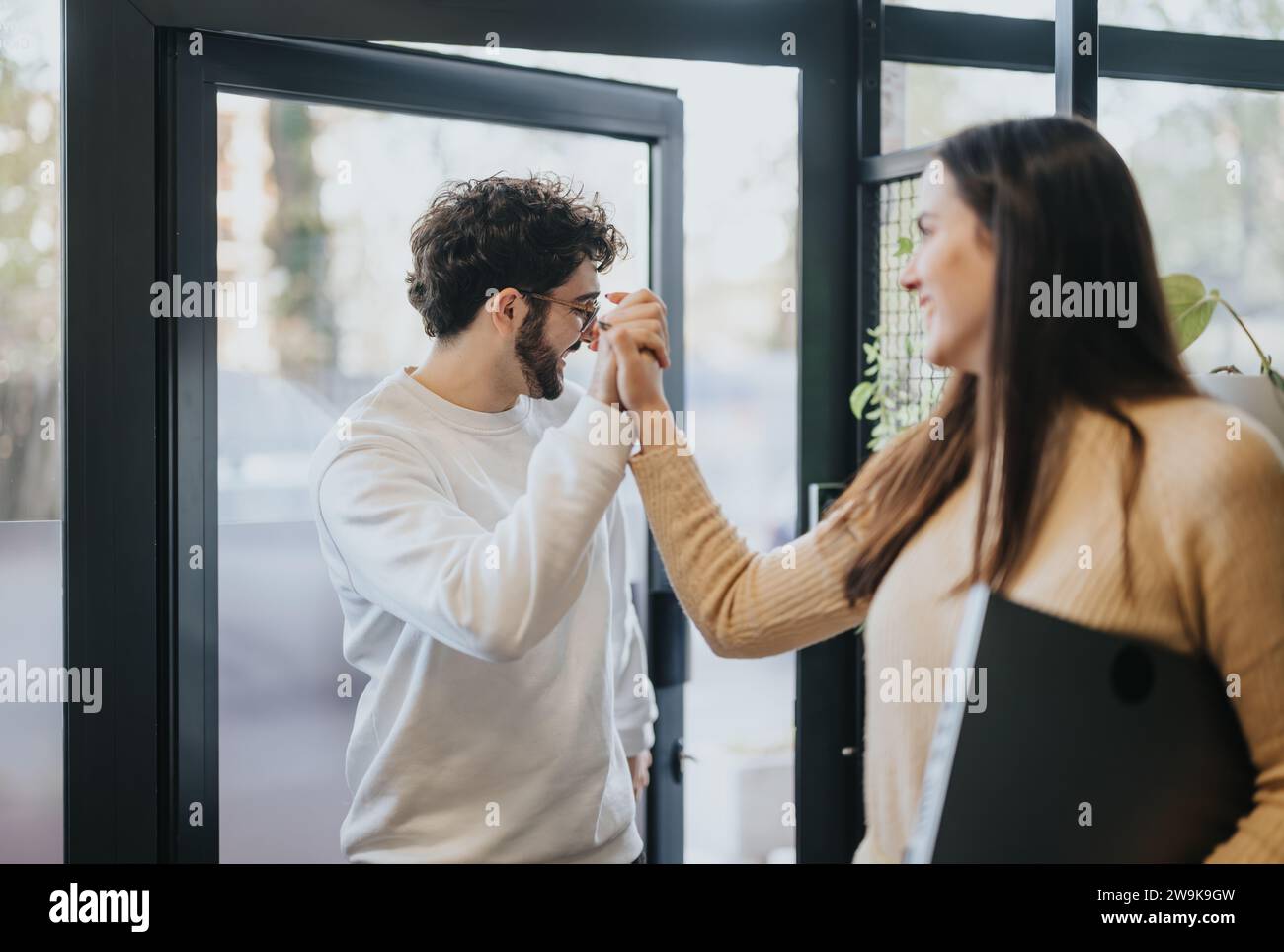 Warm greeting as the businesswoman welcomes her colleague, fostering a ...