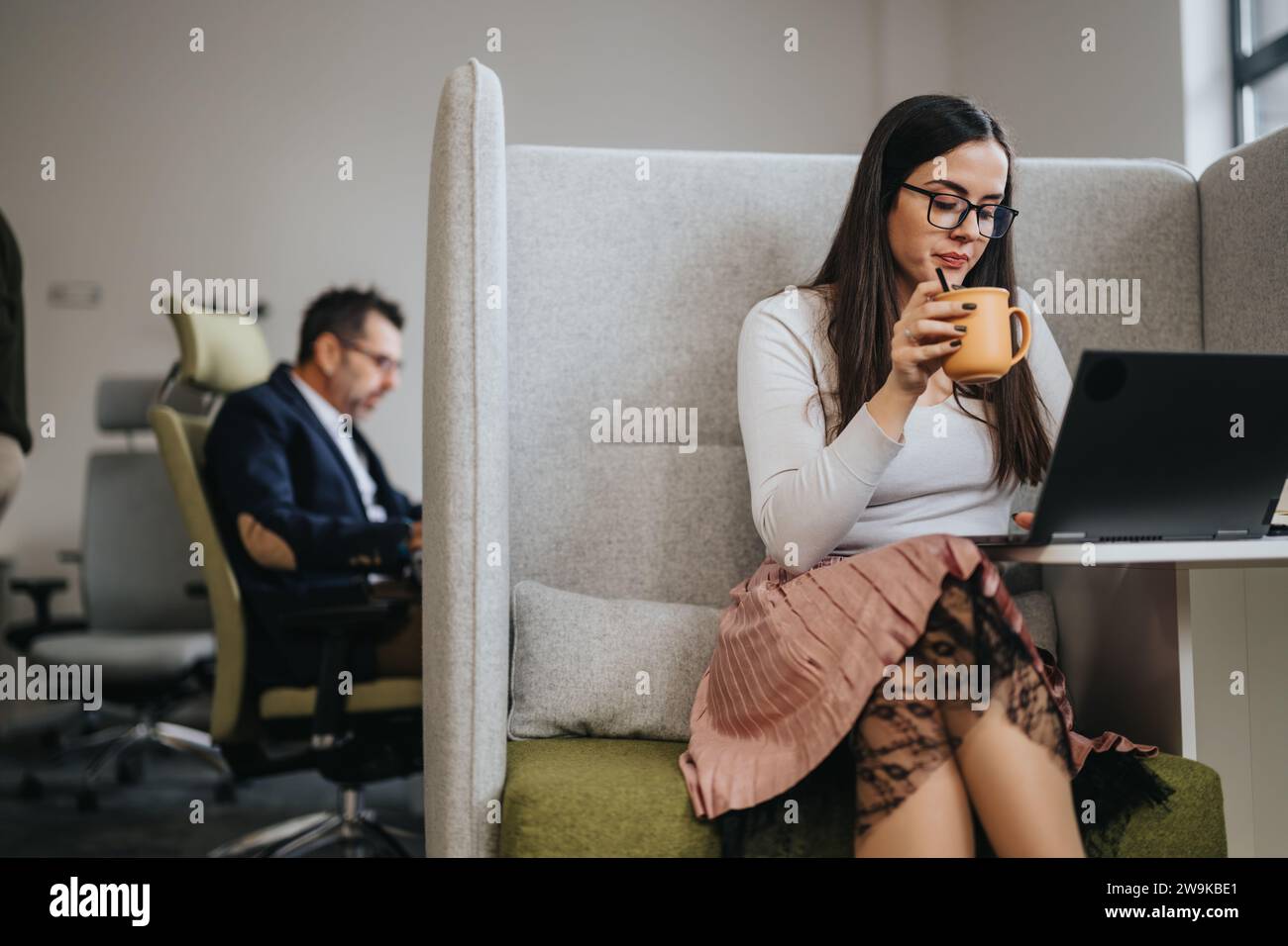 Cross generational business employees working on individual tasks using ...