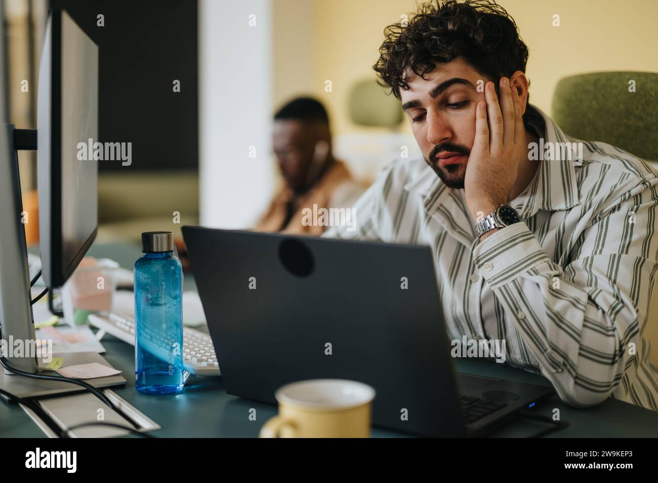 Male employee struggling to find a solution for his problem at work. He ...