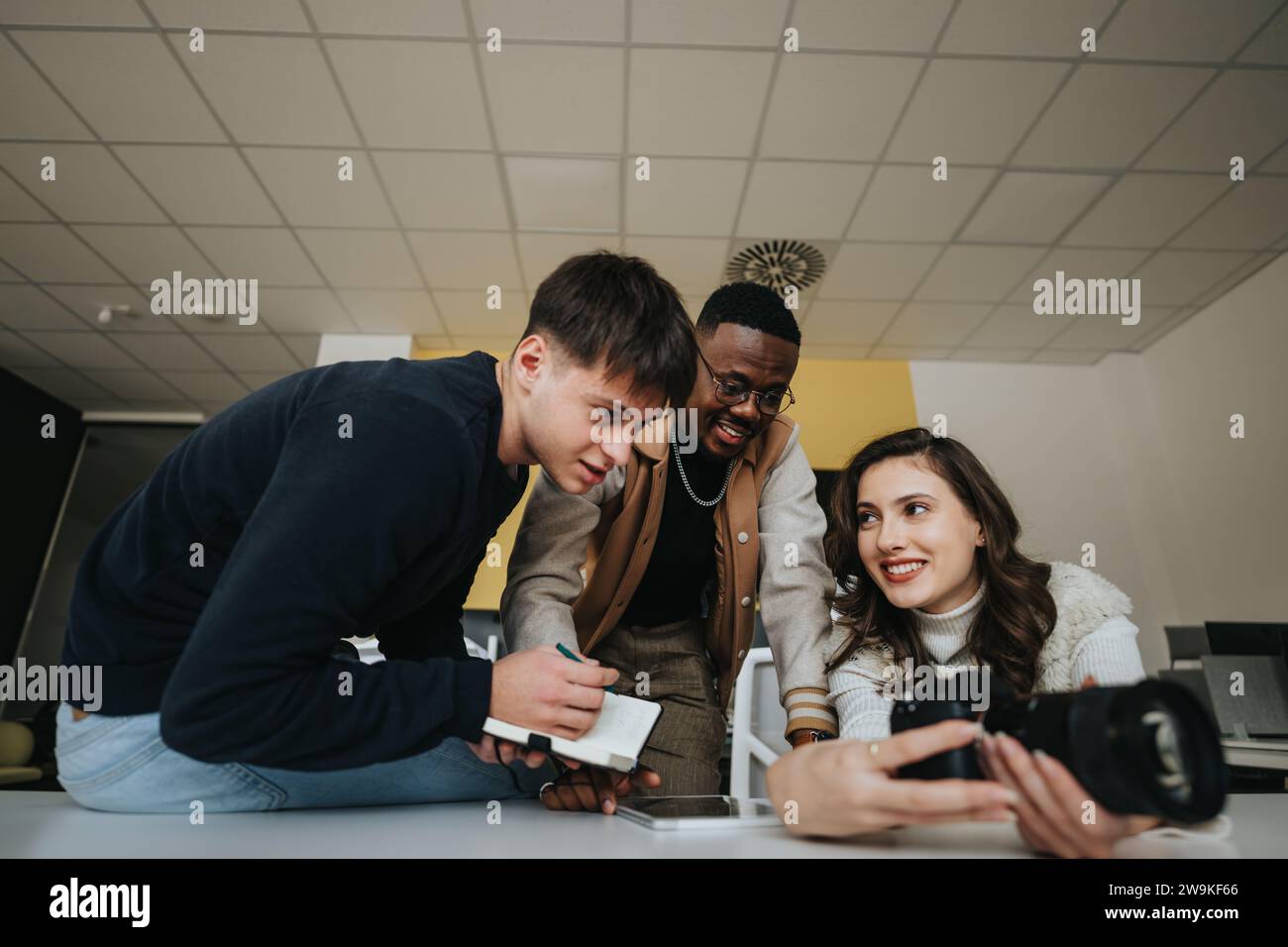 Female person showing pictures to her male colleagues Stock Photo - Alamy