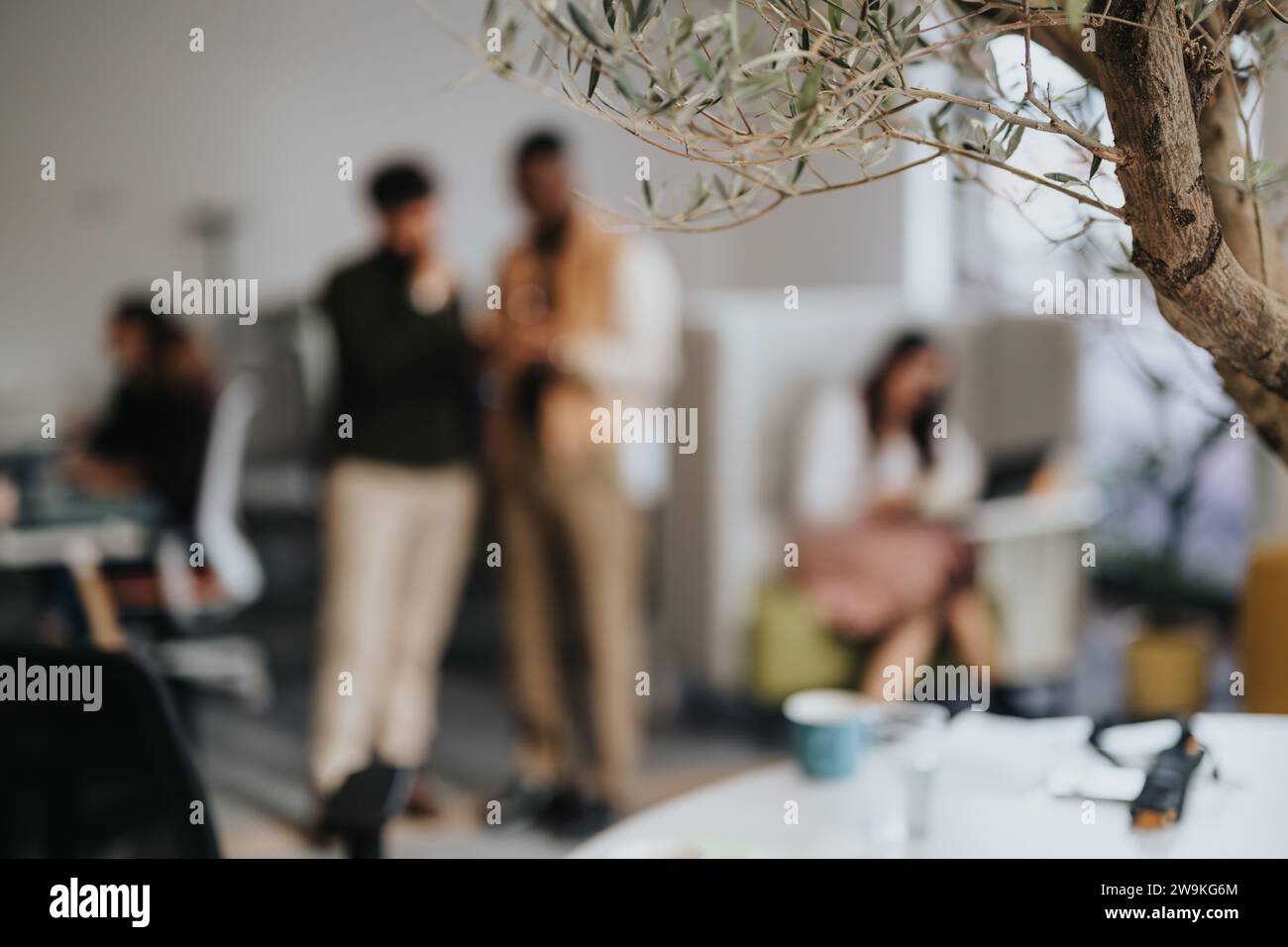 Blurred photo of business employees collaborating and discussing ...