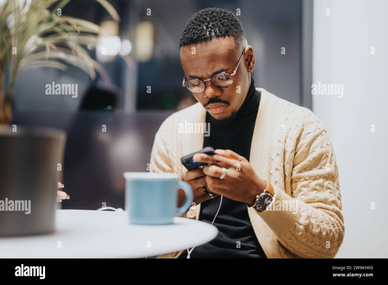 Male person watching something on the phone during late night break ...