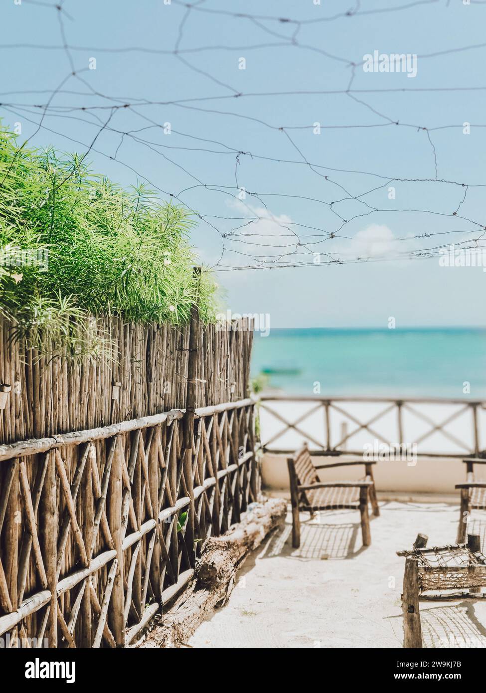 Wooden privacy fence with chairs overlooking the Indian ocean in ...