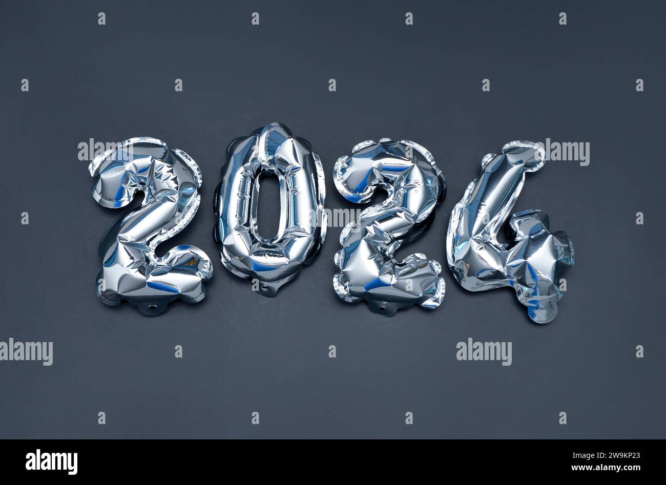 Silver foil balloons number 2024 on black background. New year concept ...