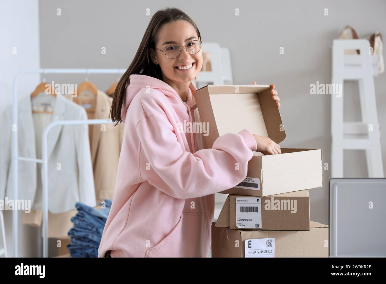 Female seller with parcels in warehouse store Stock Photo - Alamy