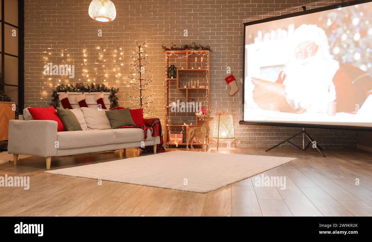Interior of living room with Christmas lights, sofa and projector ...