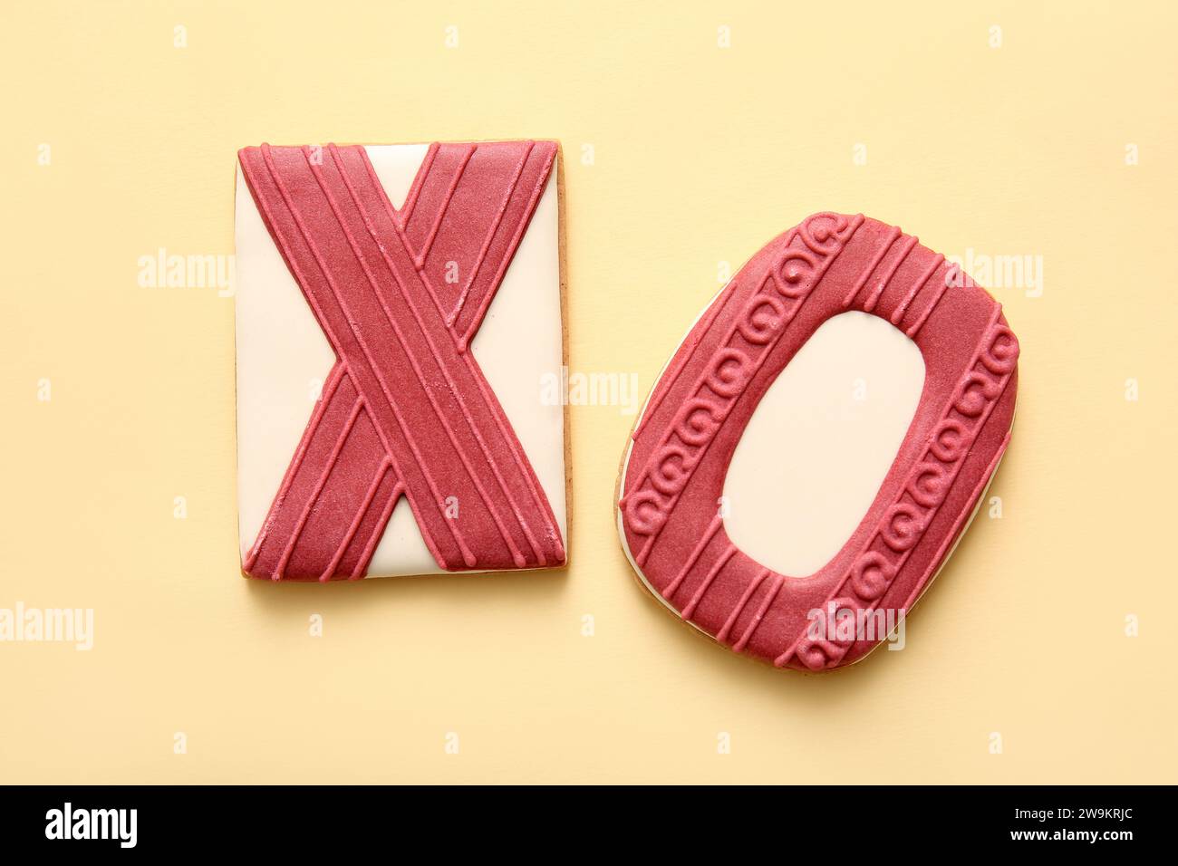 Sweet cookies in shape of XO symbol on yellow background. Valentine's ...