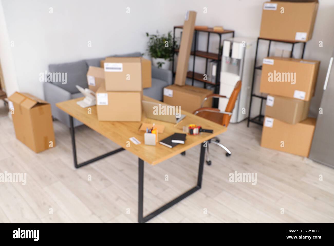 Blurred view of warehouse store with parcels and workplace Stock Photo ...