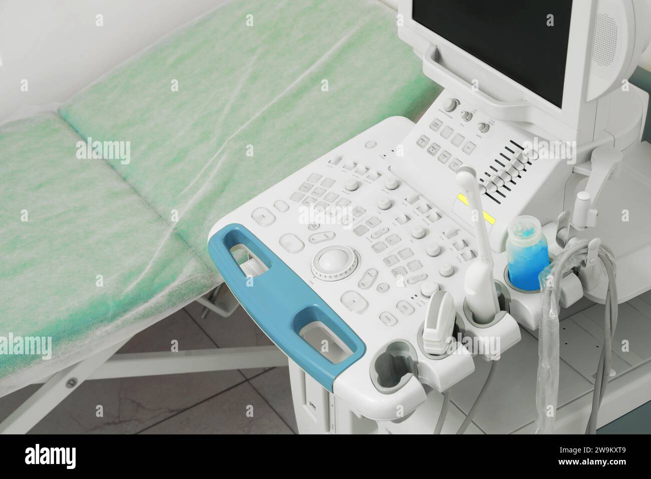 Ultrasound control panel and examination table in hospital, closeup ...
