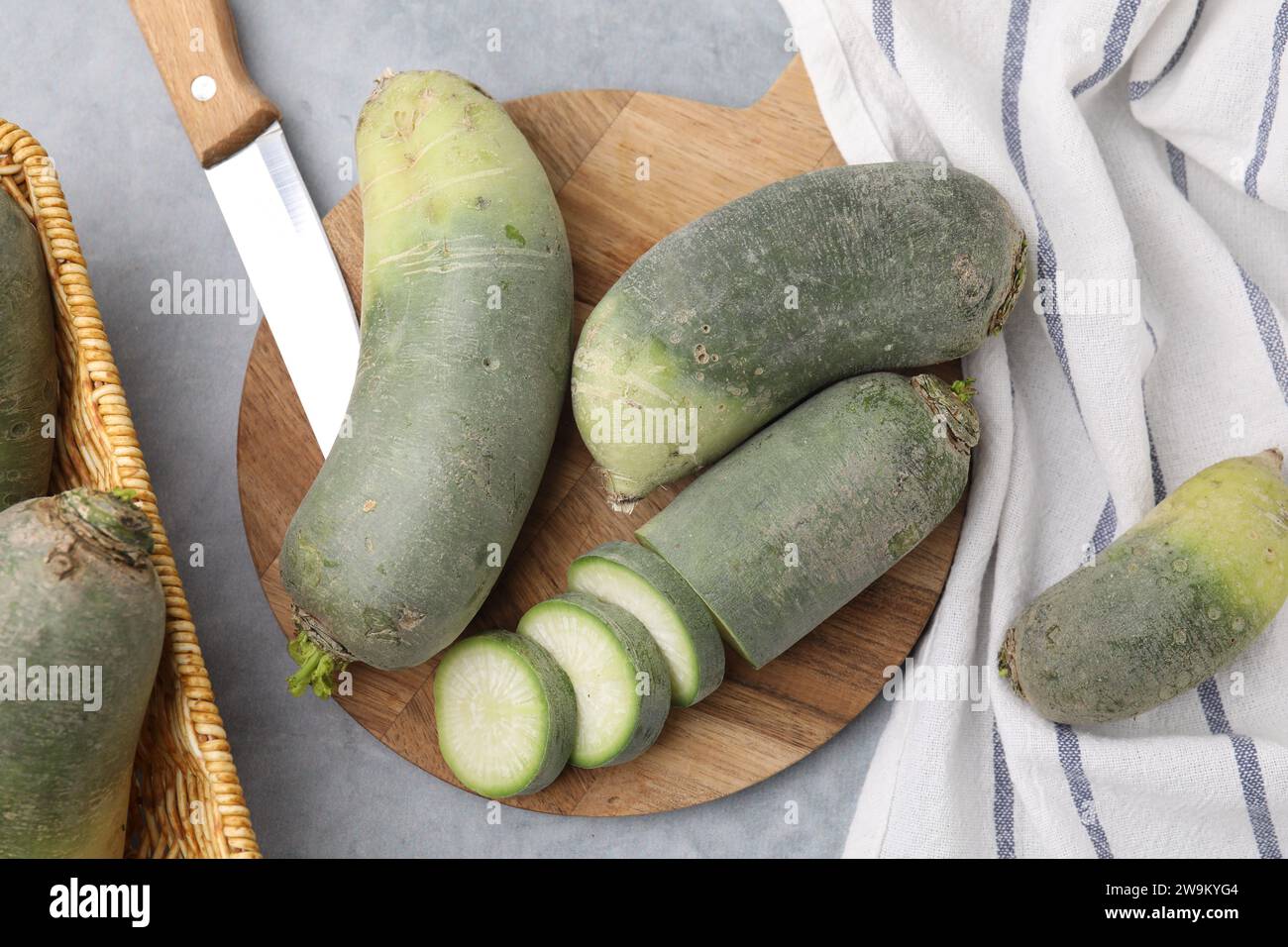 Green daikon radishes and knife on light grey table, flat lay Stock Photo - Alamy