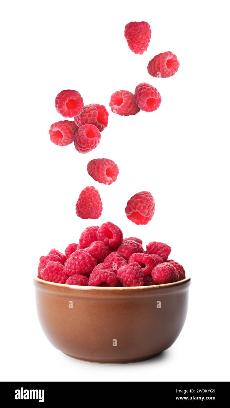 Fresh ripe raspberries falling into bowl on white background Stock ...