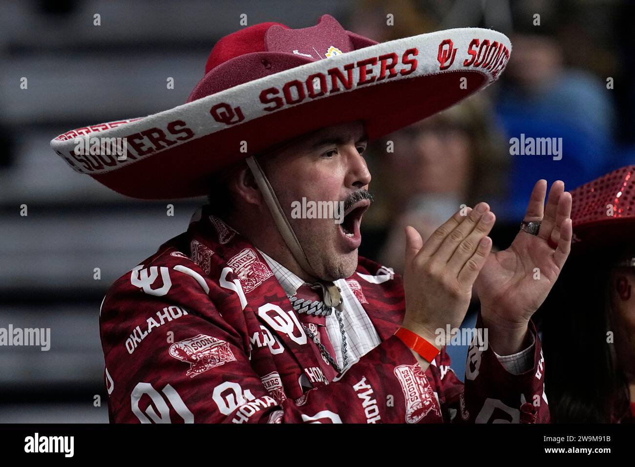 An Oklahoma fan cheers during the first half of the Alamo Bowl NCAA ...