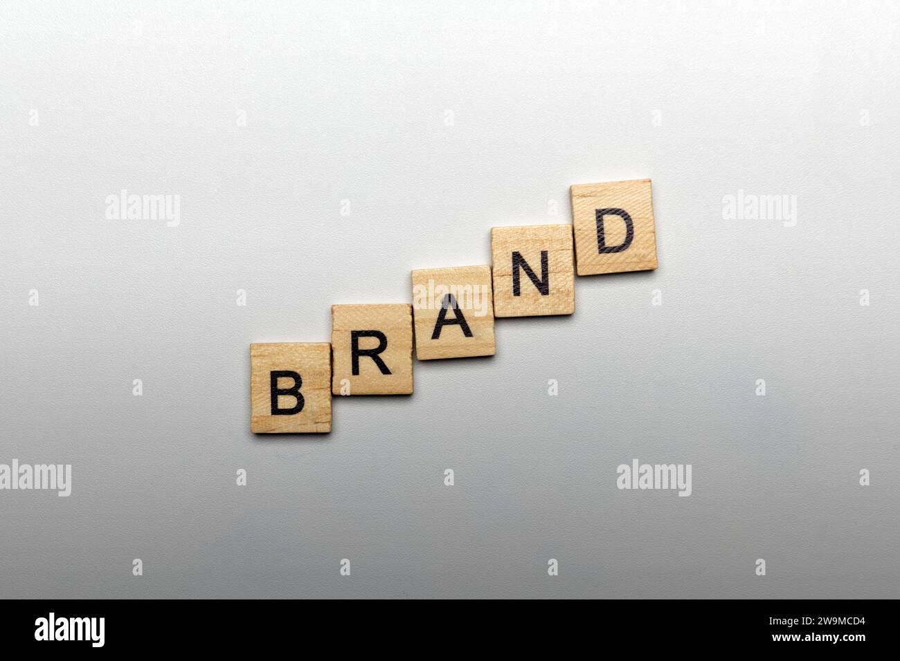 A row of wooden cubes with BRAND letters. Branding strategy concept ...