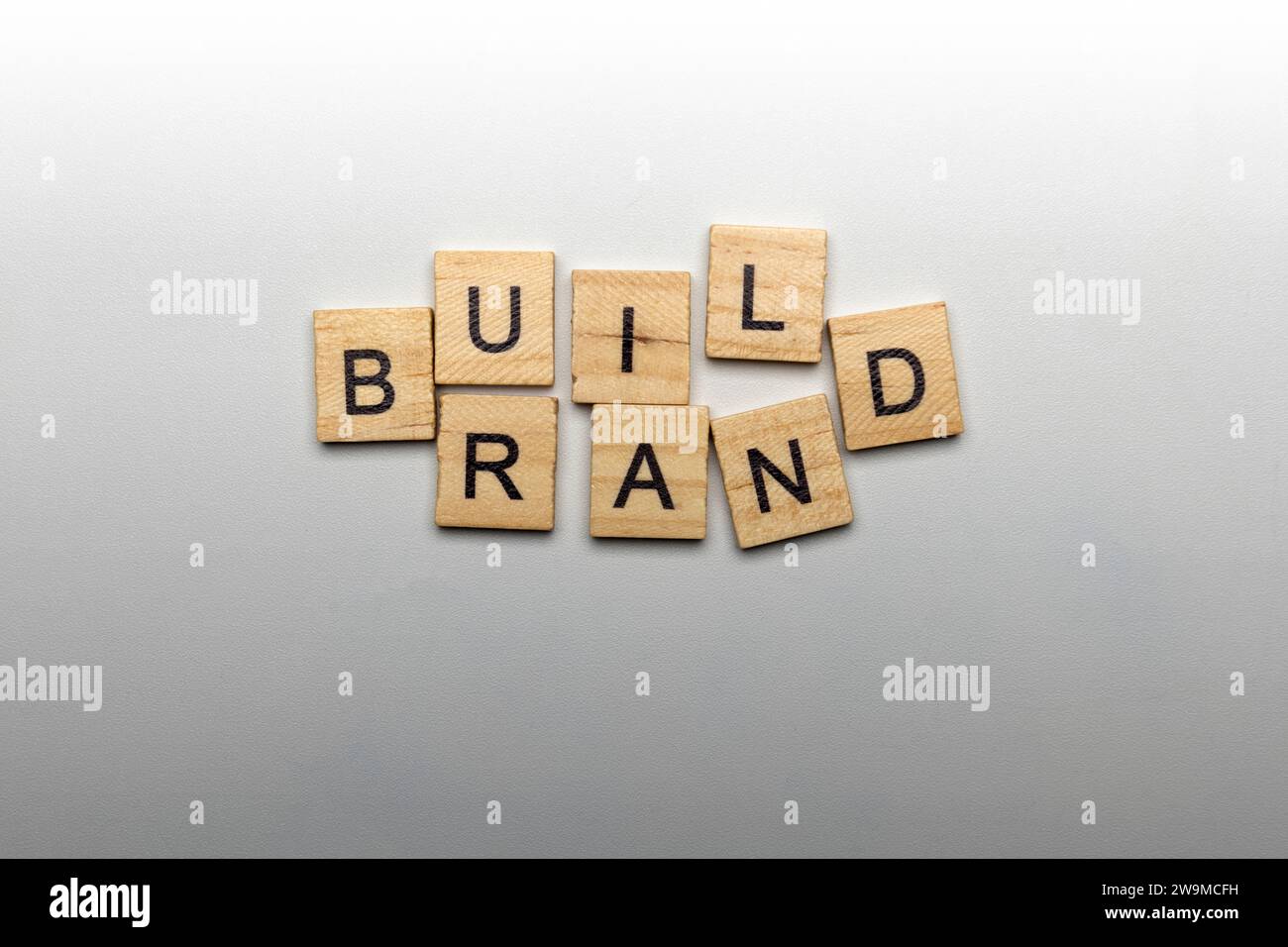 A row of wooden cubes with BUILD BRAND letters. Branding strategy ...