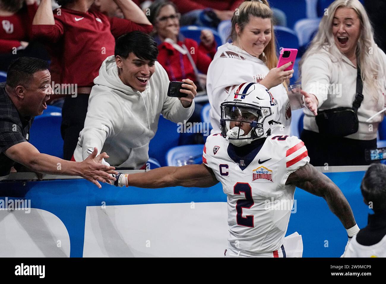 Arizona wide receiver Jacob Cowing (2) celebrates with fans after a ...