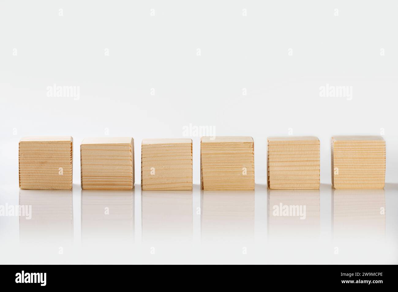A row of wooden cubes isolated over a white background Stock Photo - Alamy