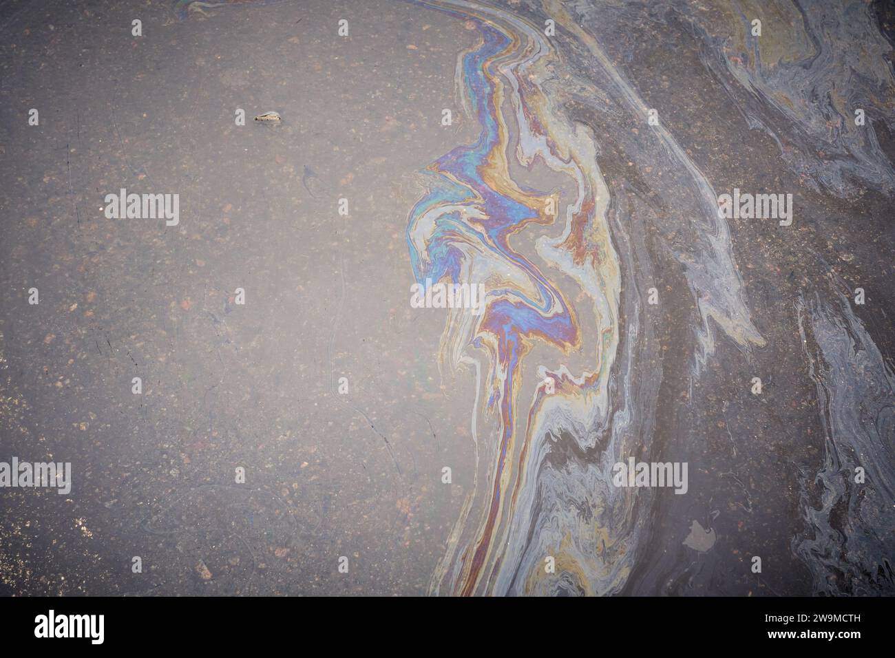 Dirty multi-colored stain from engine oil on asphalt Stock Photo - Alamy