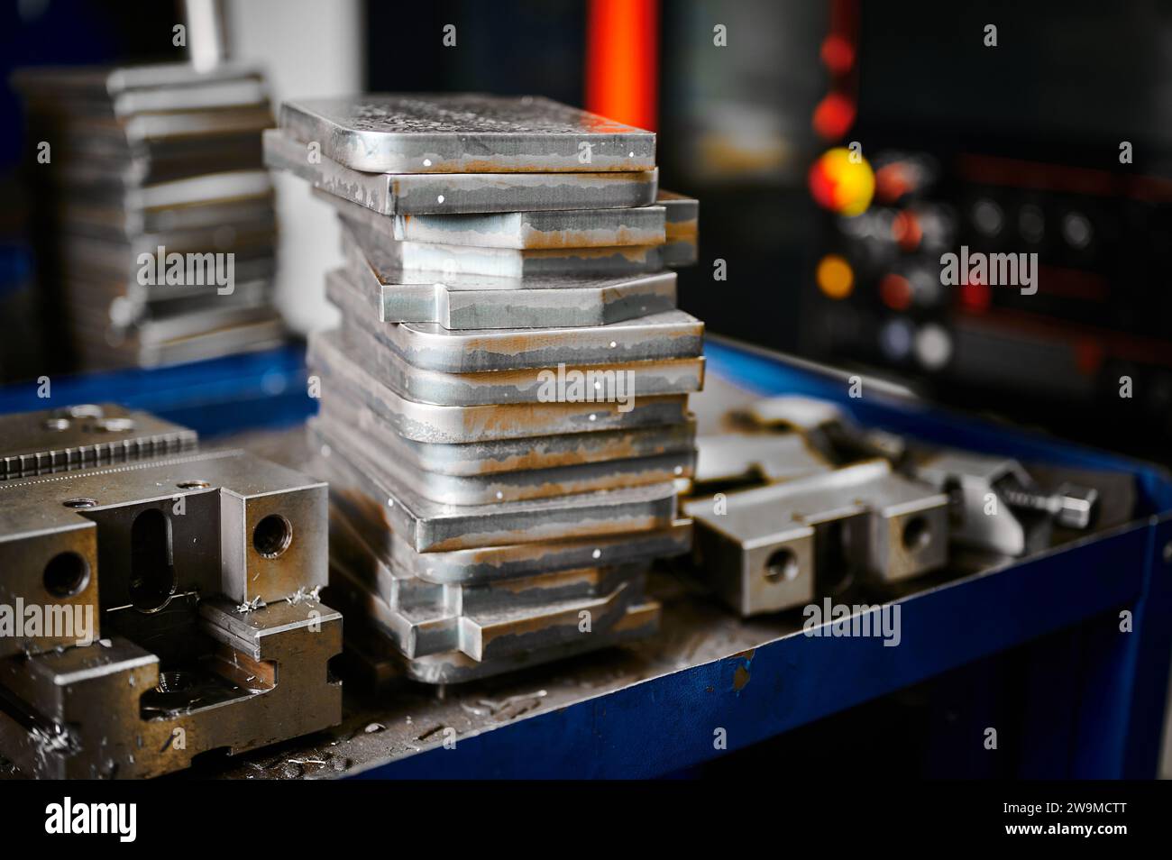 Stacks of silver metal plates on tray at production plant Stock Photo ...