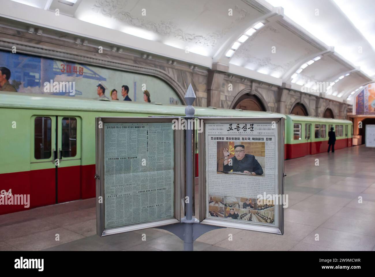 A newspaper displaying an image of Kim Jong-un on display for commuters ...