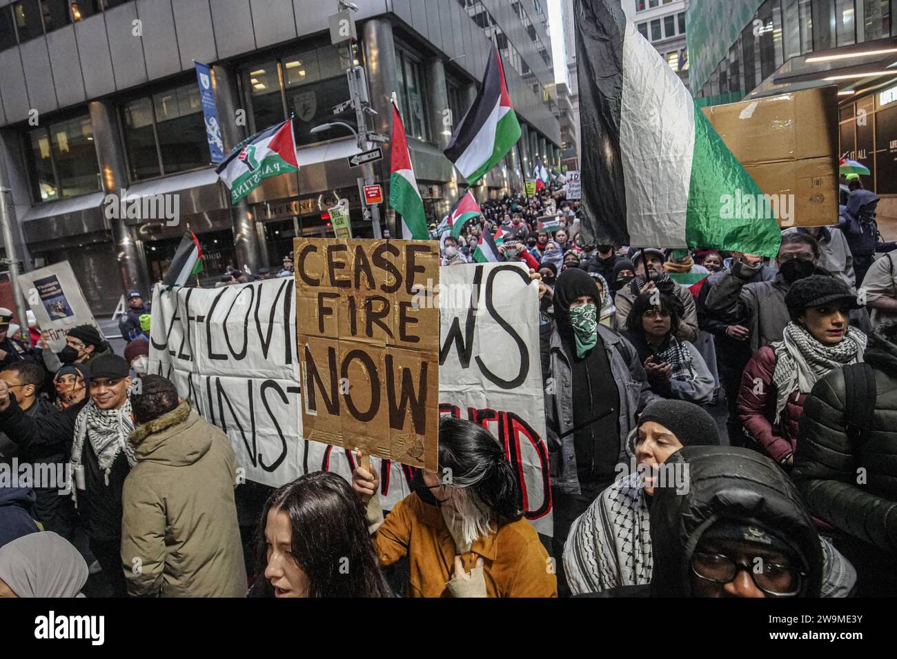 People march with placards, banners and flags on the streets of ...